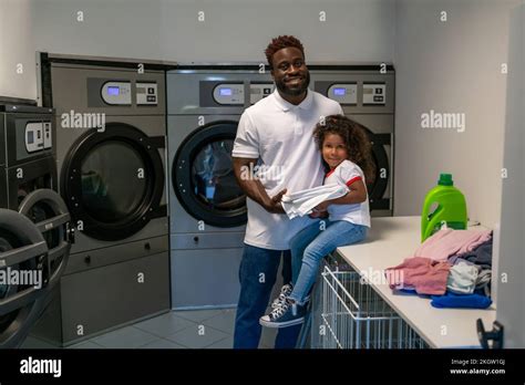Happy Dad And His Cute Daughter In A Laundry Room Stock Photo Alamy