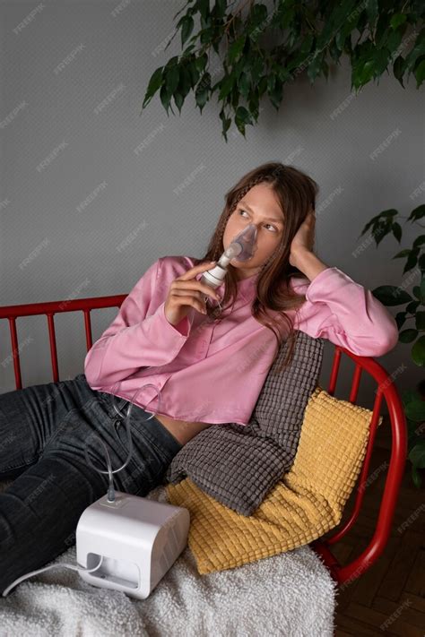 Free Photo Front View Woman Using Nebulizer At Home