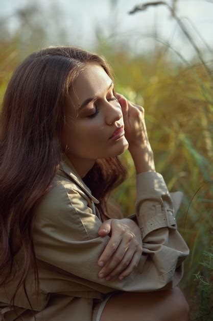 Premium Photo Dreamy Gentle Woman In A Beige Raincoat In Nature