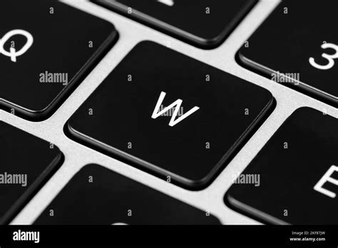 A Closeup Shot Of A Grey Keyboard Layout With Black Keys And White Font