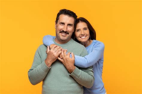 Glad European Old Woman Embraces Man From Behind With A Joyful