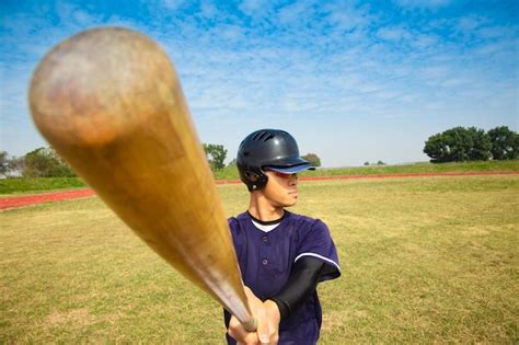 Premium Photo Baseball Player Holding Baseball Bat