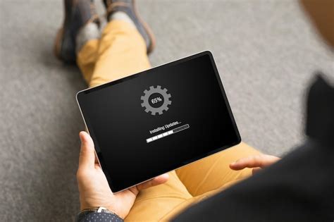 premium photo man installing software updates on tablet computer