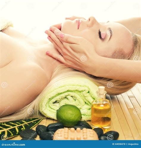 Beautiful Young Woman Receiving Facial Massage At A Spa Salon Stock