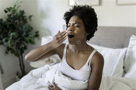 Beautiful Young African Woman In Tank Top Lying In Bed Yawn In The