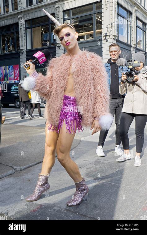 A Man Wearing Makeup And Dressed In Womens Clothing Conducting Woman On The Street Interviews