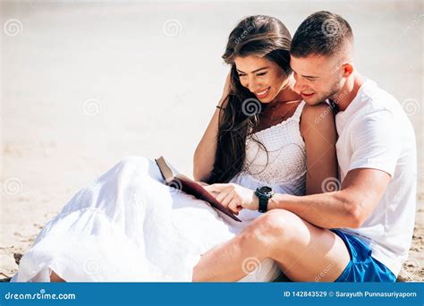 Man Reading Book With His Girlfriend Outdoors Stock Image Image Of Reading Holidays 142843529