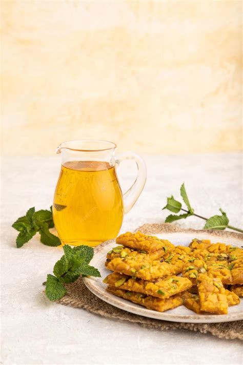 Premium Photo Traditional Iranian Dessert Sohan With Glass Of Green