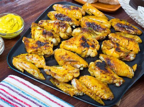 Picture Of Dish Of Tasty Fried Chicken Wings Served In Black Pan Stock