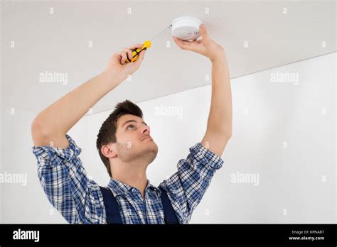 Electrician Repairing Fire Sensor Stock Photo Alamy