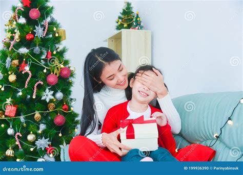 Asian Mom Covering Her Daughterâ€™s Eyes Making Surprise With A T