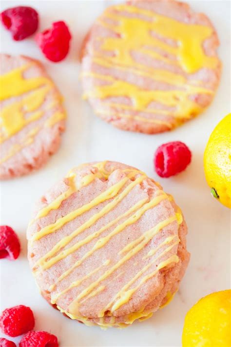 Raspberry Lemon Cookies With Icing And Fresh Raspberries On The Side