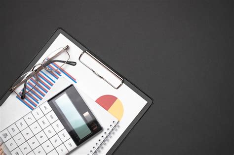 Premium Photo Office Workplace Table With Calculator Graphs And Glasses