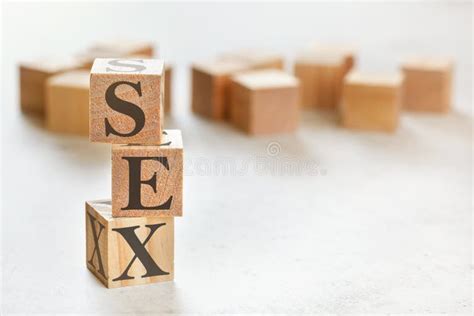Three Wooden Cubes With Word Sex On White Table More In Background Space For Text In Right