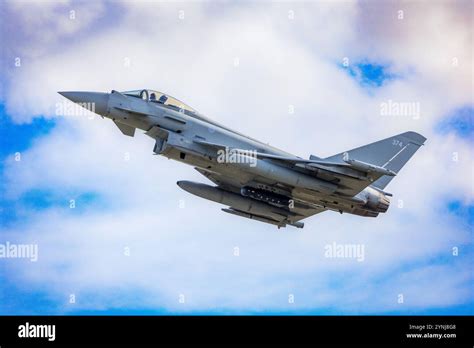 A Eurofighter Typhoon Soars Through A Vibrant Sky Equipped With