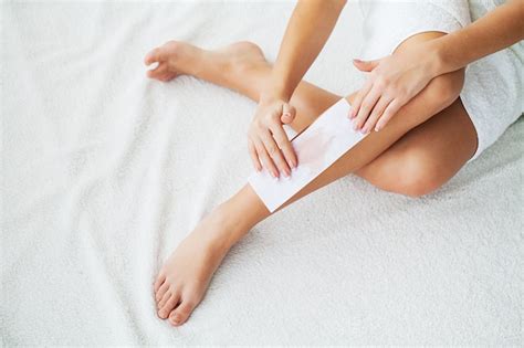 Premium Photo Waxing Beautician Waxing Womans Leg In Spa Salon