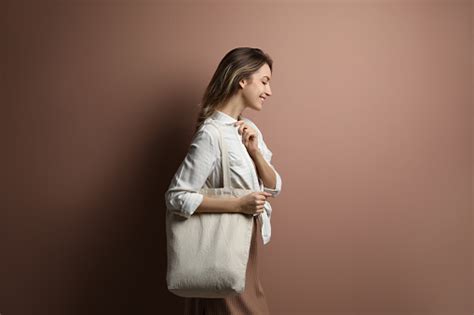 明るい茶色の背景に空白の環境にやさしいバッグを持つ幸せな若い女性 1人のストックフォトや画像を多数ご用意 1人 25 29歳