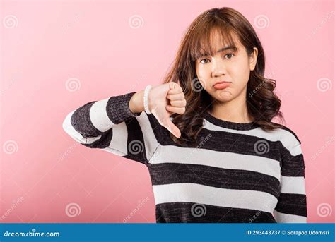Portrait Of An Asian Woman Expressing Dissatisfaction With A Thumbs