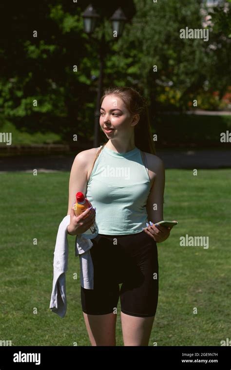 Candid Portrait Of Young Woman In Sportswear After Outdoor Workout In