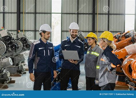 Engineers Working Robot Assembly Industry Plant In Factory Talking Meeting Examining