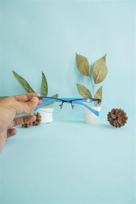 Vertical Photo Glasses Hands Pine Flowers And Green Leaves On Pink