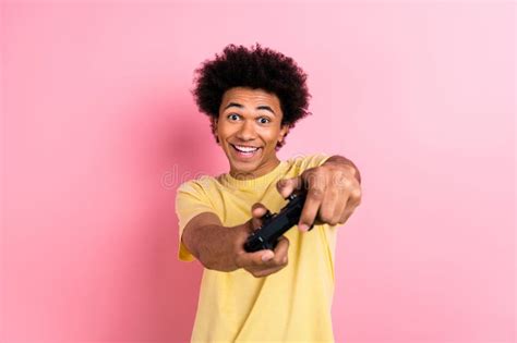 Photo Of Pretty Excited Guy Dressed Yellow T Shirt Enjoying Playstation