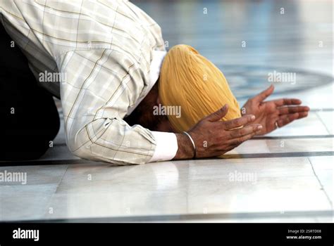 Sikh Devotee Bowing In Front Of Golden Temple Amritsar Punjab India