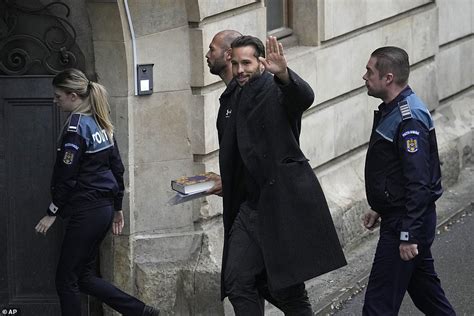 Andrew Tate And Brother Tristan Arrive Handcuffed At Romanian Court