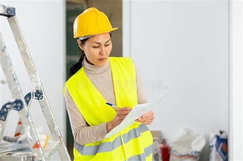 Woman Worker Filling Documents During Repair Works Indoors Stock Image