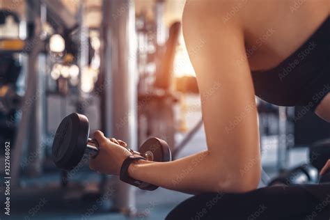 Sexy Women Lifting Dumbbells Workouts With Dumbbells In A Gym Sport