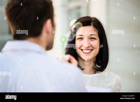 Man Blowing Bubbles From Bubble Blower On His Girlfriend Outdoor In Street Stock Photo Alamy