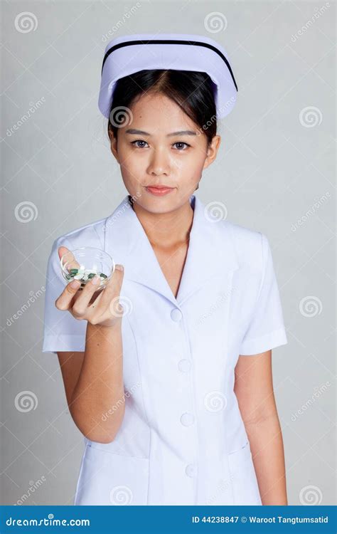 Young Asian Nurse With Pills In Small Cup Stock Image Image Of Clinic