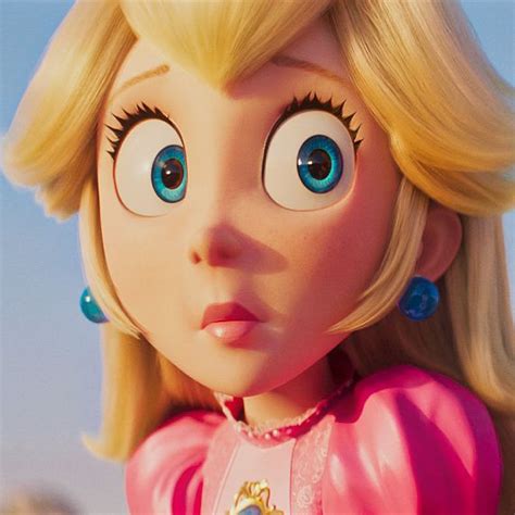 A Close Up Of A Cartoon Character With Big Blue Eyes And Blonde Hair Wearing Pink