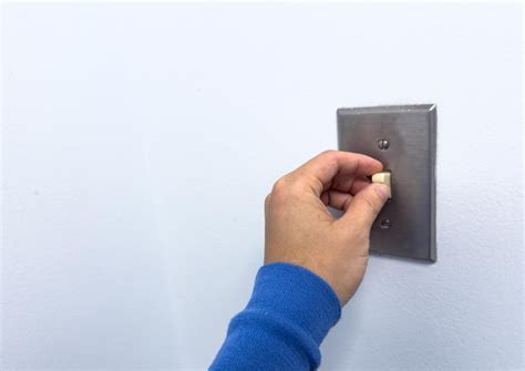 Premium Photo Glowing Light Switch Against Dark Background Symbolizing Power Control And