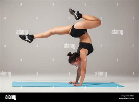 Beautiful Sporty Girl Standing In Acrobat Pose Or Yoga Asana Stock