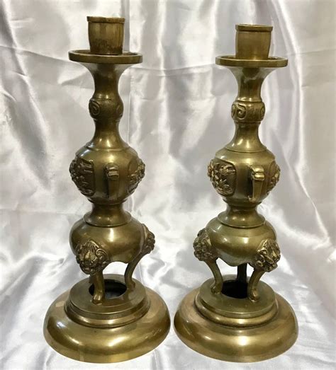 Pair Of Brass Taper Candlesticks With Flowers And Griffins For Sale At