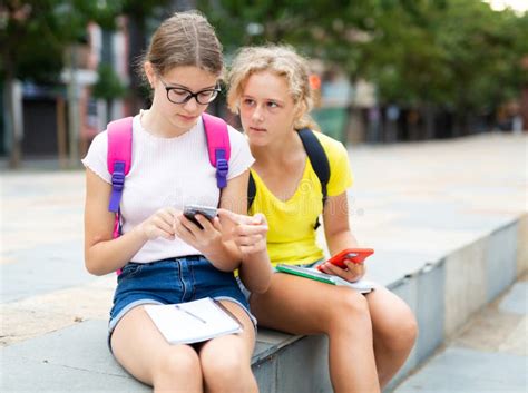 Two Schoolgirls Doing Their Homework Outdoors Stock Image Image Of
