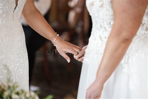 Beautiful Two Brides At Same Sex Couple Wedding Ceremony Holding Hands