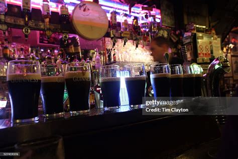 Pre Poured Pints Of Guinness On The Bar At Odonoghues Bar Dublin