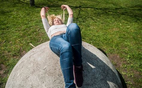 Premium Photo High Angle View Of Woman Lying On Rock At Grassy Field