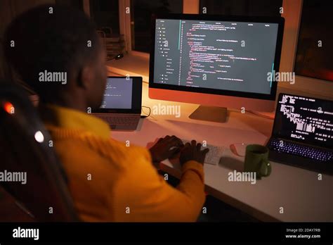 Back View Portrait Of African American Man Writing Code While Working