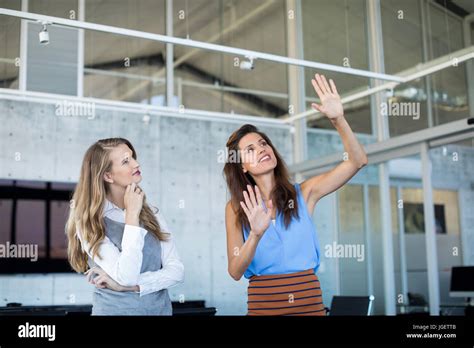 Female executives interacting with each other in office Stock Photo - Alamy