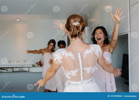Bride And Bridesmaids Having Fun In Hotel Room On Wedding Day Stock