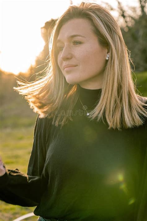 Vertical Portrait Of An Attractive Blonde Girl Looking To The Side