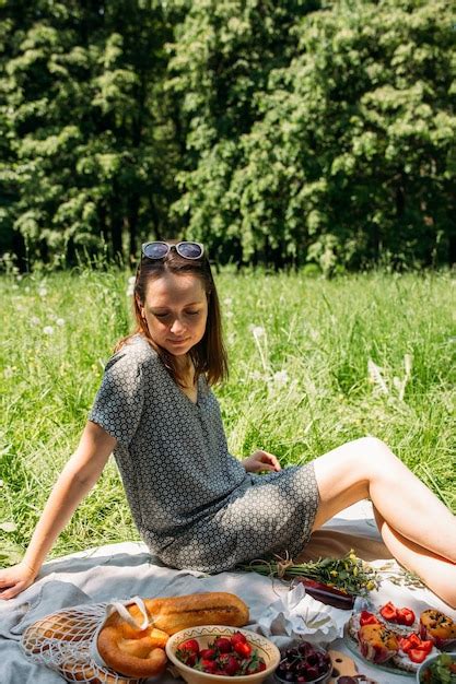 Premium Photo Young Woman Sitting On Grass