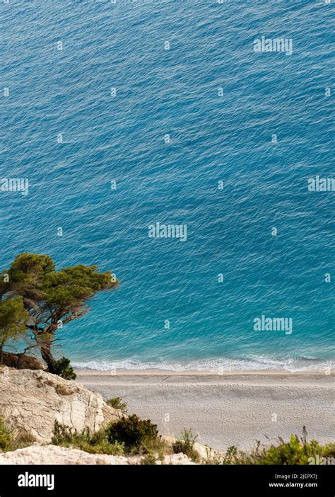 Beautiful Wild Mediterranean Pebble Beach Under A Large Massive Cliff