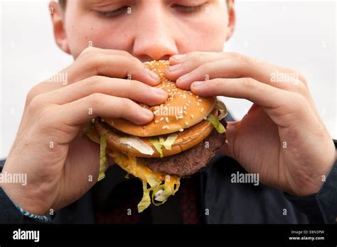 A Teenager Eating A McDonald S Big Mac Burger Stock Photo Alamy