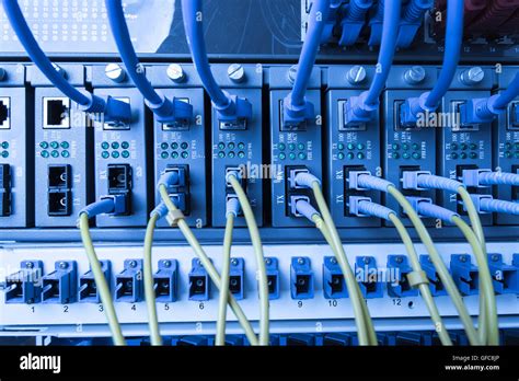 Fiber Network Switch With Some Yellow Optical Network Cables Stock