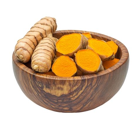 Fresh Turmeric Root And Dried Turmeric Slices In A Wooden Bowl On A