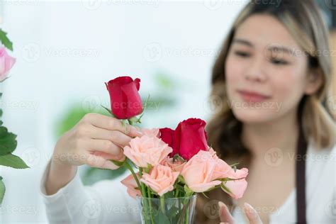 Beautiful Asian Woman Florist Holding Bouquet Of Roses In Flower Shop